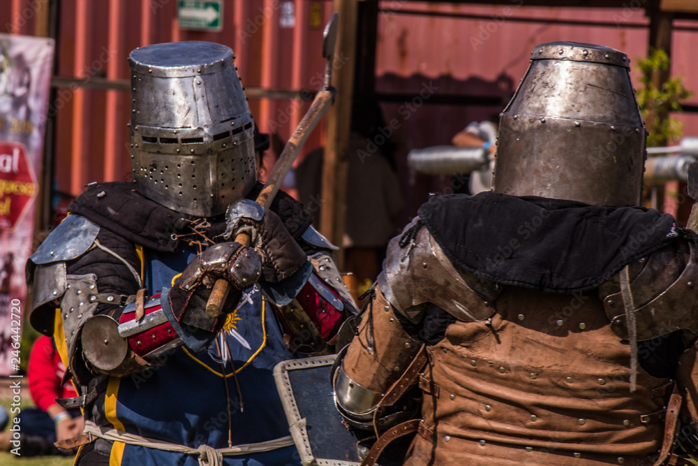 Medieval knights fighting with armor, swords and shields in festival ...