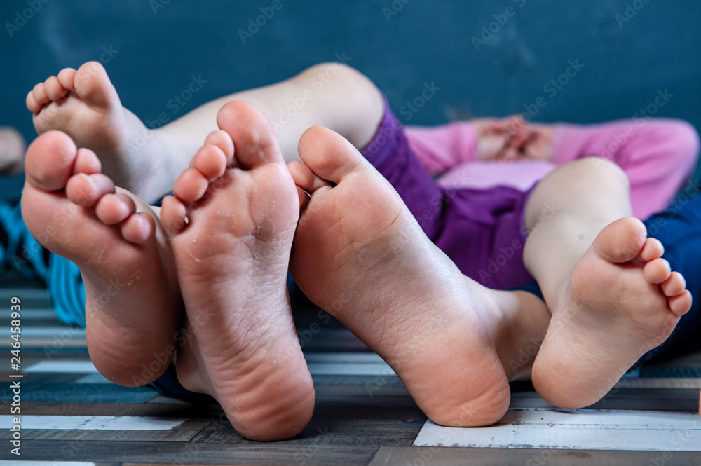 Three children are sitting on floor in room and are going to do ...