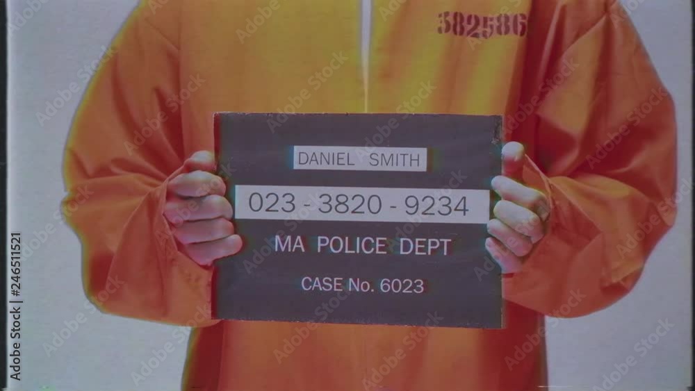 Video „Mugshot at a police station of a criminal in an orange suit. 80s ...