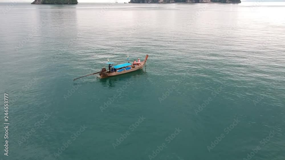 Drone footage of longtail boat navigating around islands of Thailand ...