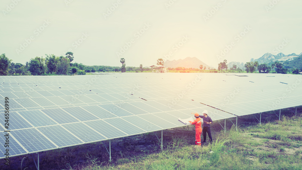 engineer in solar power plant working on installing solar panel ; smart ...