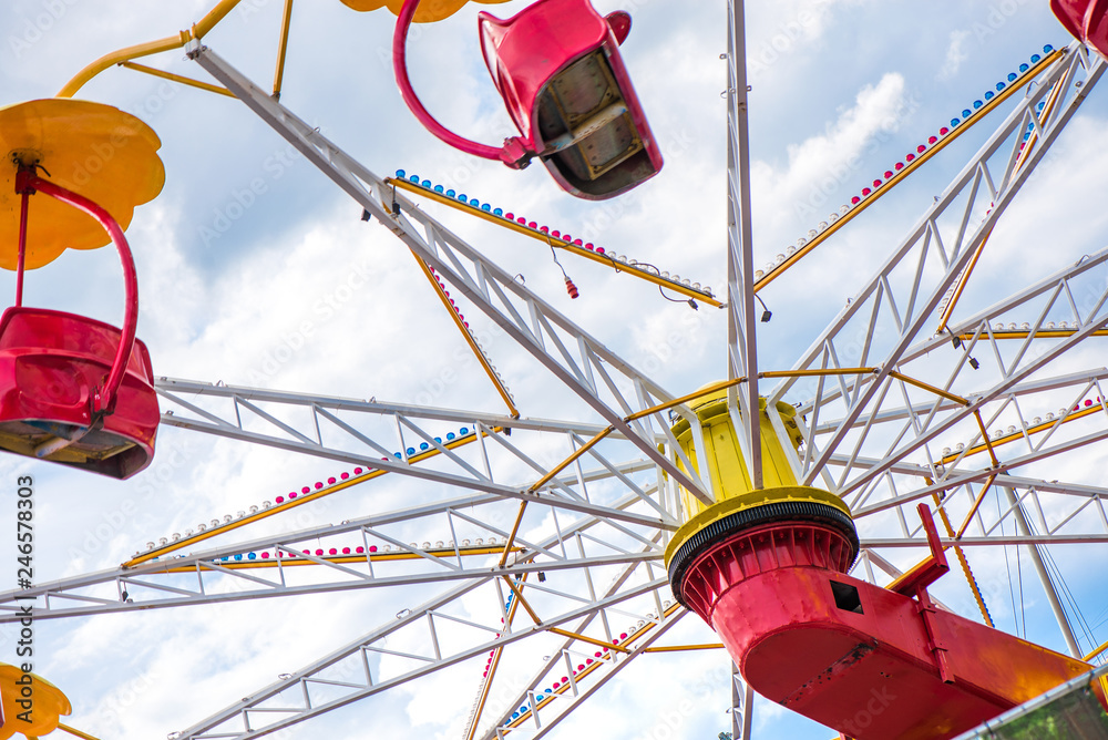 Colorful roller coaster seats at amusement park. People having fun in ...