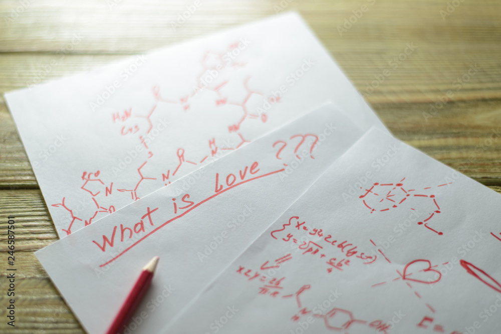 The concept of love as hormones. Sheets of paper written with formulas ...