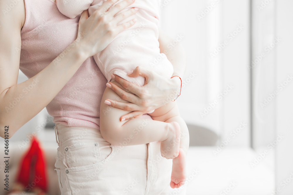 Child`s buttocks picture with copy space. Unrecognizable mother holding ...
