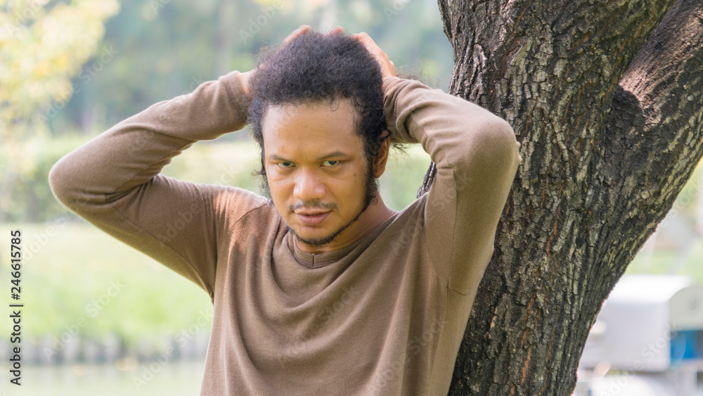 facial expression of confused young man who has troubles uses hand to ...
