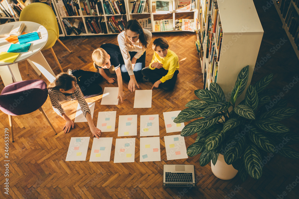 Two creative female students making project organizing tasks and ...