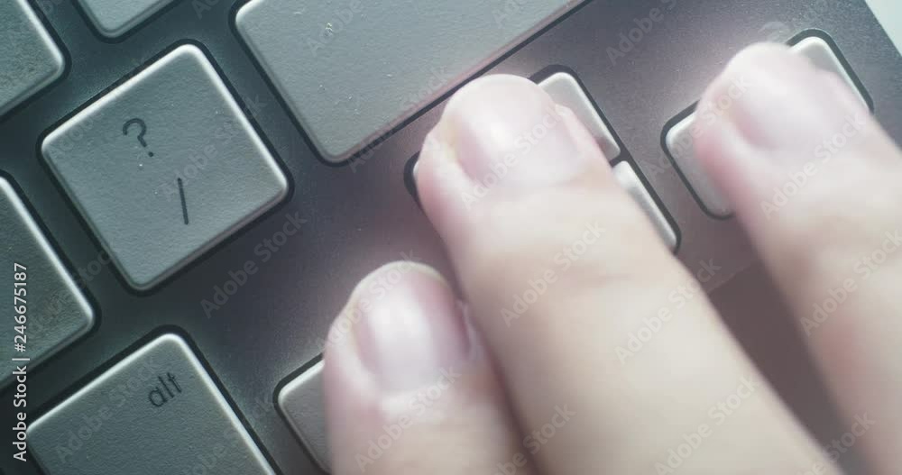 Close-up 4K dutch angle shot of fingers hitting the Arrow keys on a Mac ...