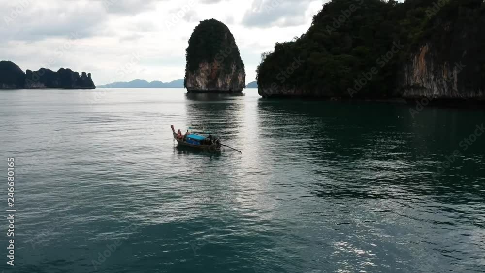 Drone footage of longtail boat navigating around islands of Thailand ...