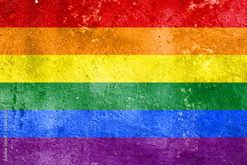 Rainbow flag on concrete wall. Symbol of sexual minorities and ...