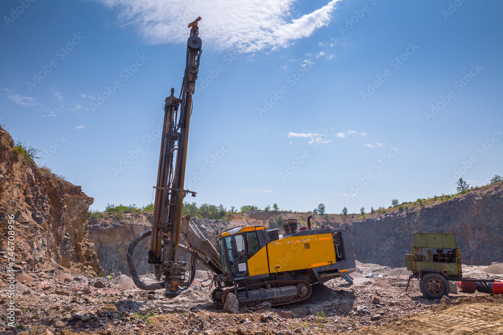 Deep surface drill rig in a quarry open pit mining of granite stone ...
