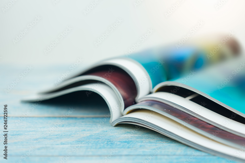 Stack magazines on wooden table Stock Photo | Adobe Stock