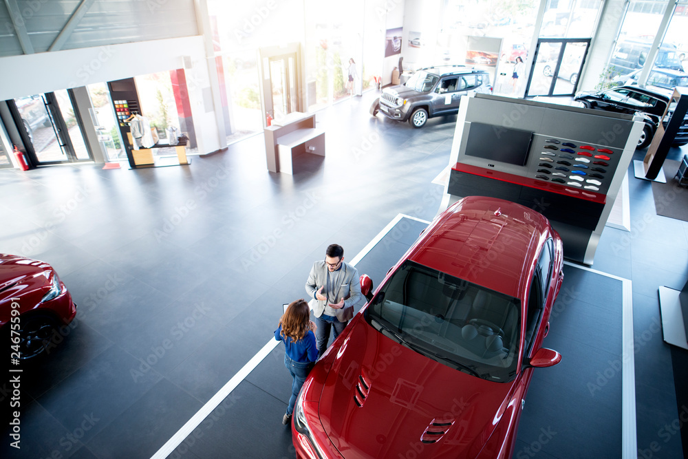 Car dealership showroom top view. Car dealer presenting vehicle to the ...