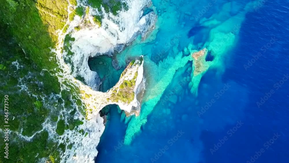 Aerial bird's eye view video taken by drone of caves and boats docked ...