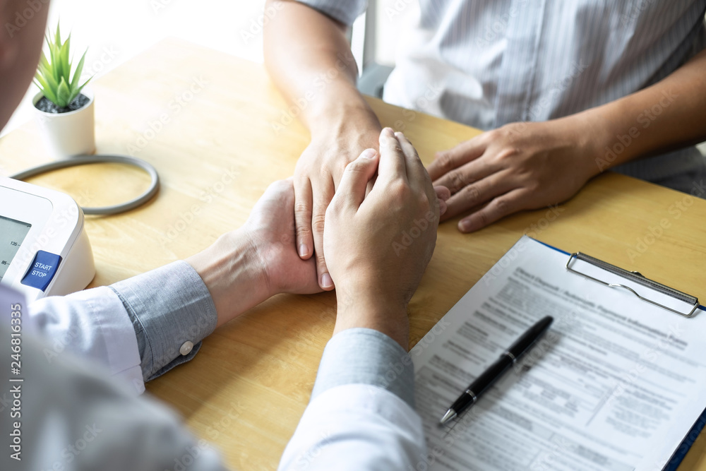 Image of doctor holding patient's hand to encourage, talking with ...