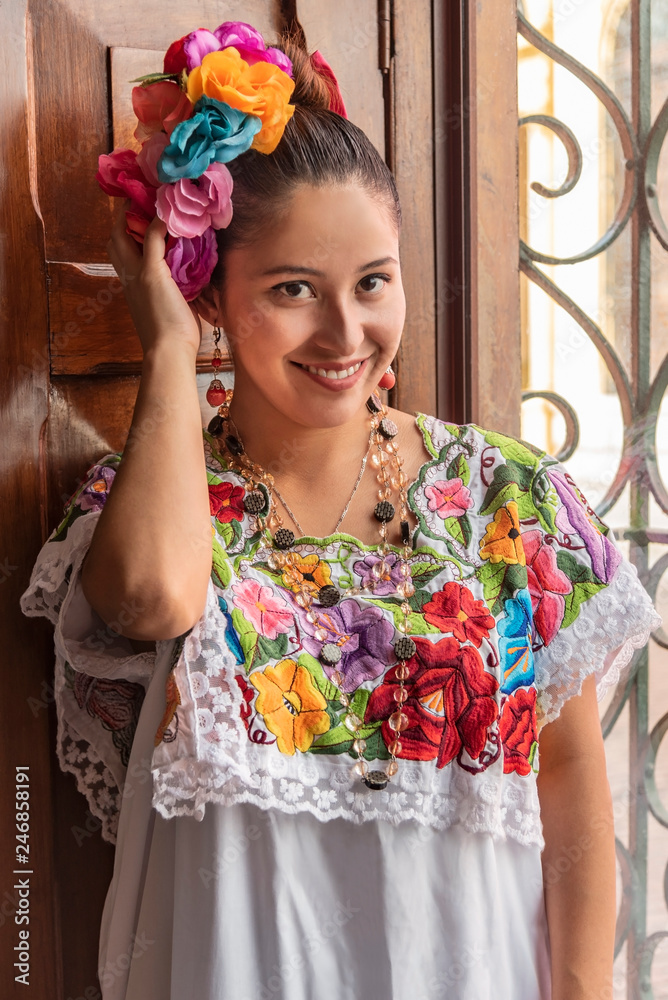 Pretty and colorful Mayan girl in Yucatan. Young smiling girl inviting ...