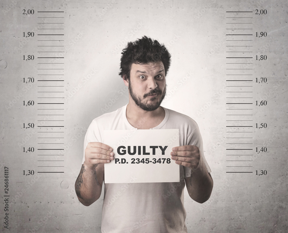 Caught guilty man with ID signs on his hand. Stock Photo | Adobe Stock