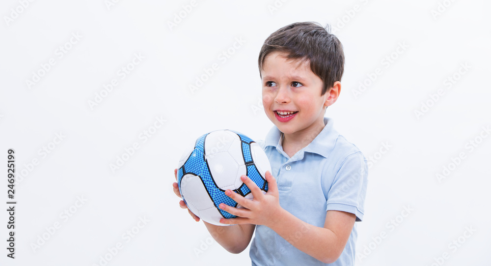 Boy playing with soccer ball, isolated on white studio background ...