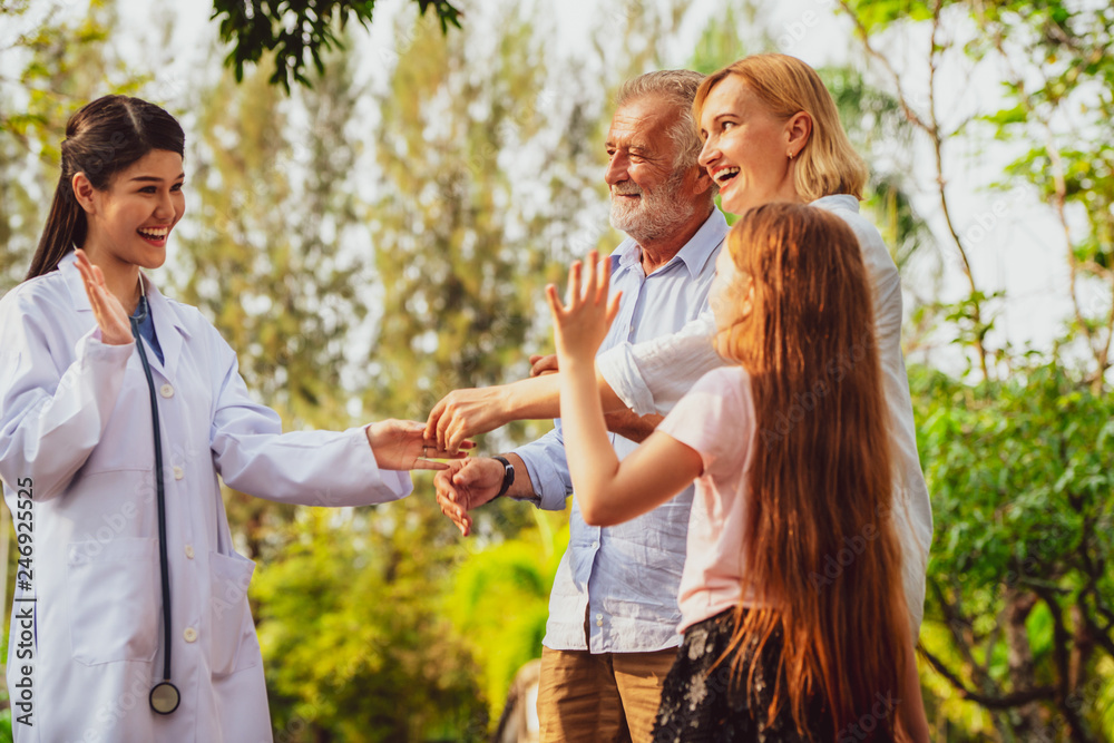 Happy healthy family and doctor talking in the park. People healthcare ...