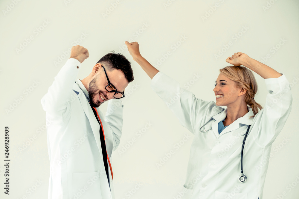 Happy successful doctor celebrates victory in hospital office with ...