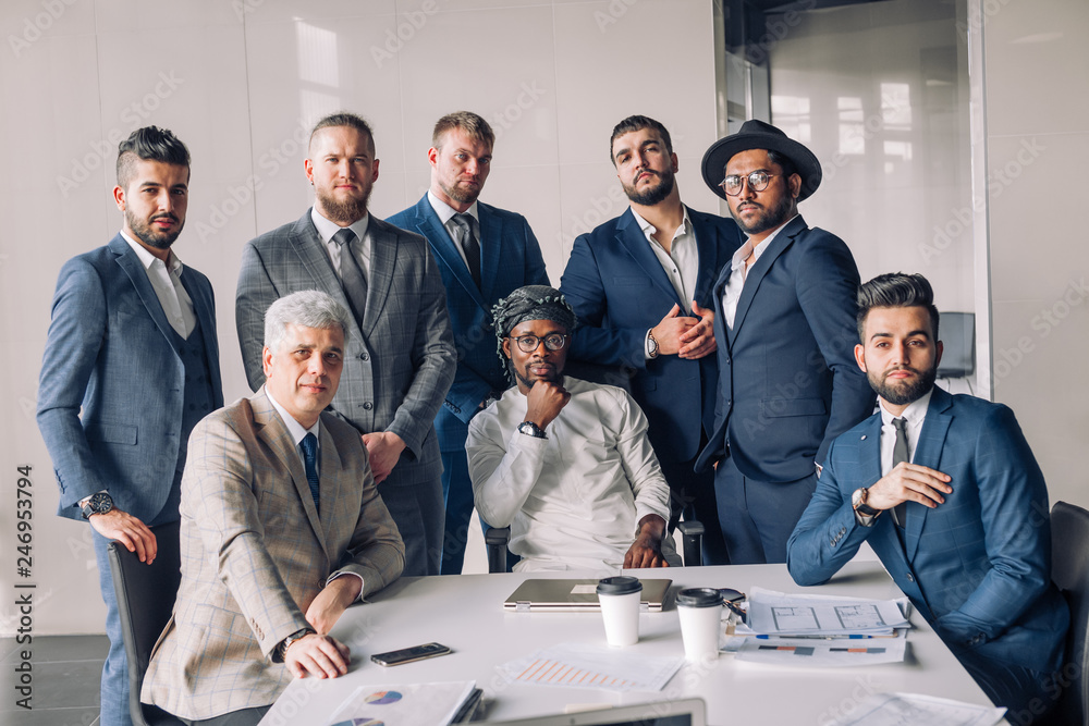 Portrait of Male business team in busines suits looking at camera ...
