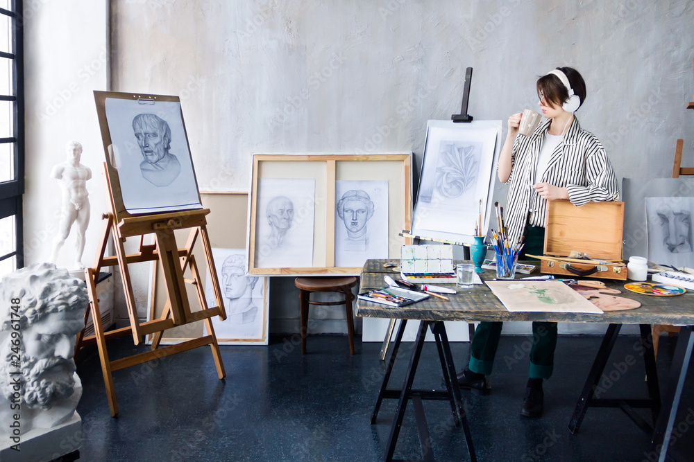 Modern freelancer artist sculptor woman in headphone creates new art ...