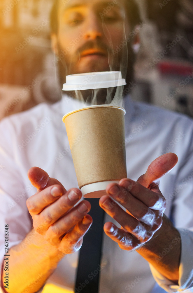 Barista in a white shirt with a tie holds floating in the air a paper ...