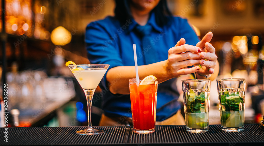 Female mixologist bartender at work preparing making serving alcoholic ...