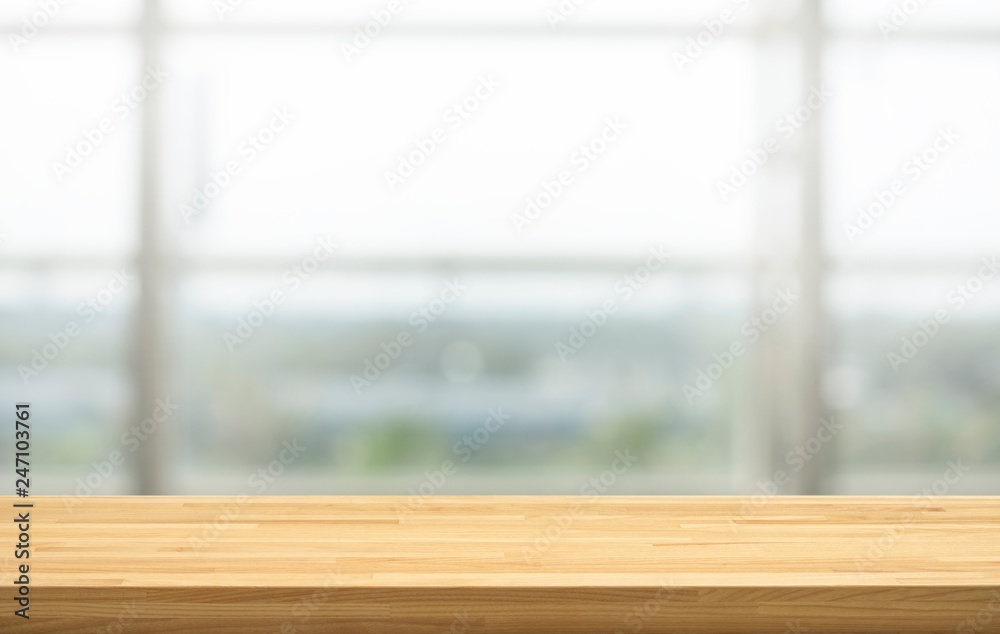 Wood table top on blur window glass, restaurant wall background.For ...