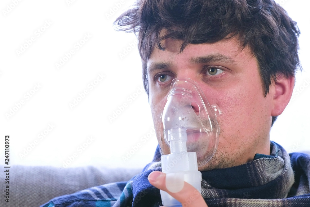 Foto de Use nebulizer and inhaler for the treatment. Sick man inhaling ...