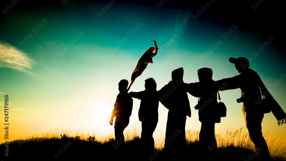 A Team holding Thailand flag and Move forward over head in sunset sky ...