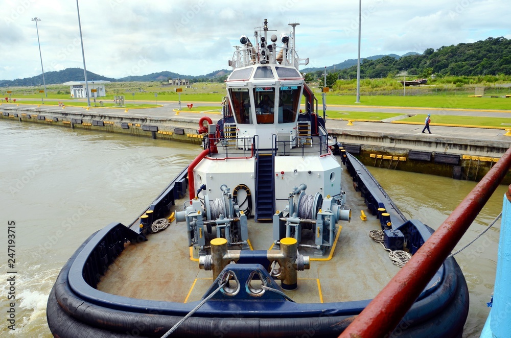 Tug boat assisting to the vessel in the Cocoli Locks, Panama Canal ...