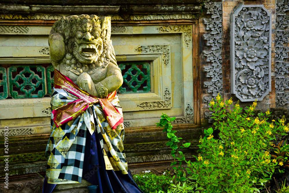 Stone statue of monster guard in front of old ancient historical temple ...