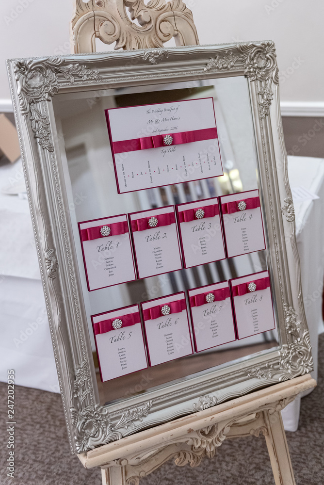 Wedding table seating plan placed on antique vintage mirror Stock Photo ...