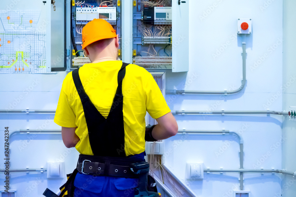 Electrician at work. A man collects electrical wiring. Construction ...