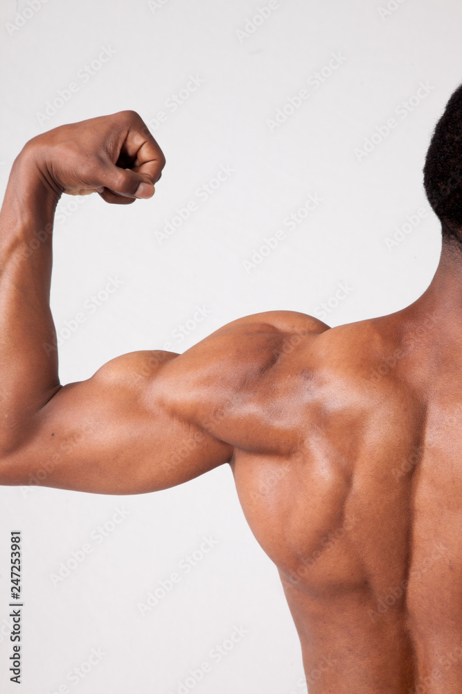 Strong Black man flexing muscles Stock Photo | Adobe Stock