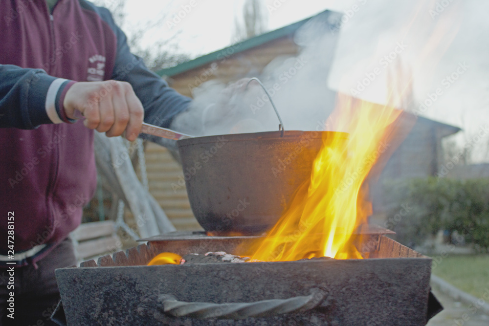 Picnic in nature. Cooking on a fire on the grill on the nature ...