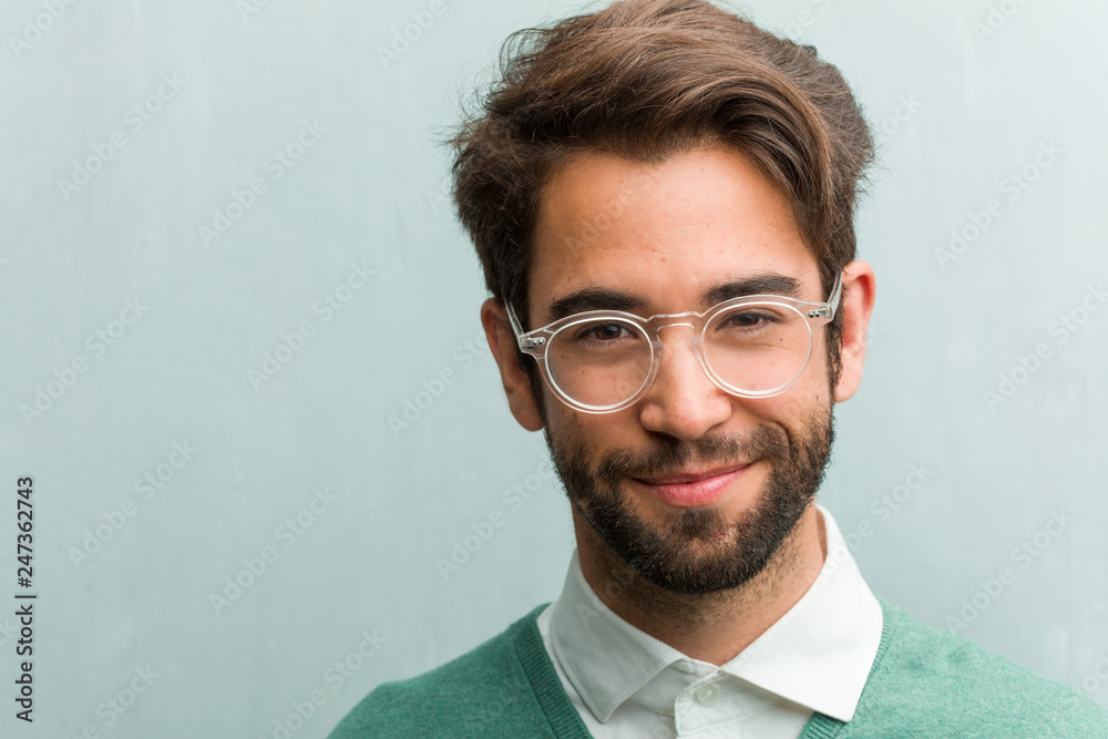 Young handsome entrepreneur man face closeup cheerful and with a big ...