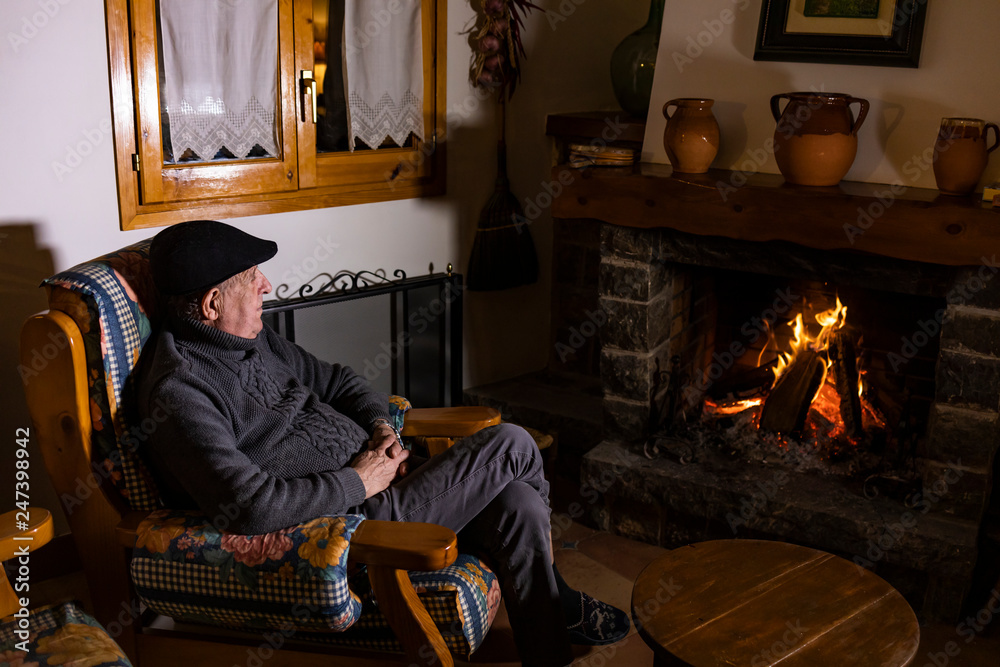 Elderly People Sitting By Fireplace