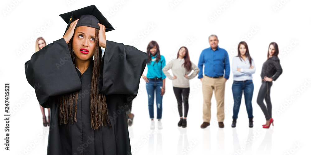 Young graduated black woman wearing braids worried and overwhelmed ...