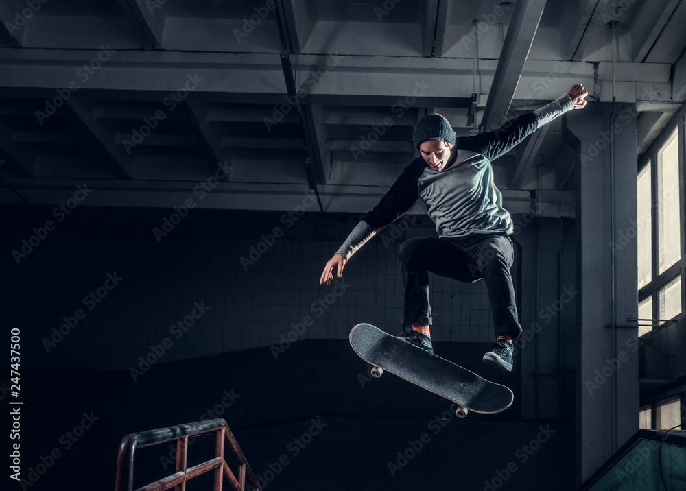 Skateboarder jumping high on mini ramp at skate park indoor. Stock ...