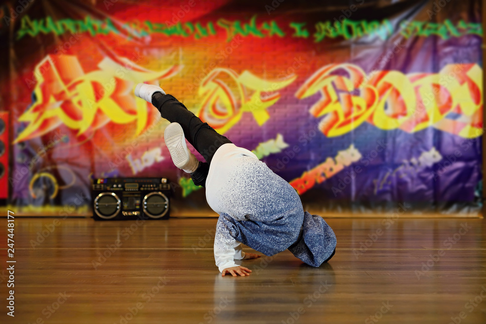 dancer in a breakdance pose on a background of graffiti and boombox ...