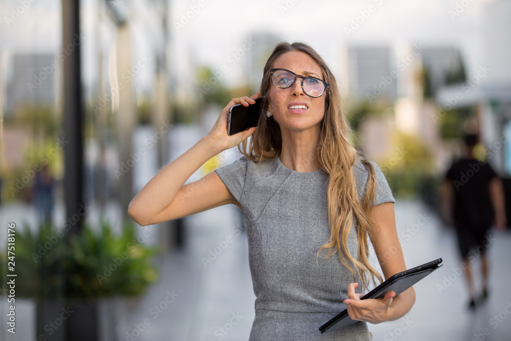 Stressed business person struggling to use cellphone, bad reception ...