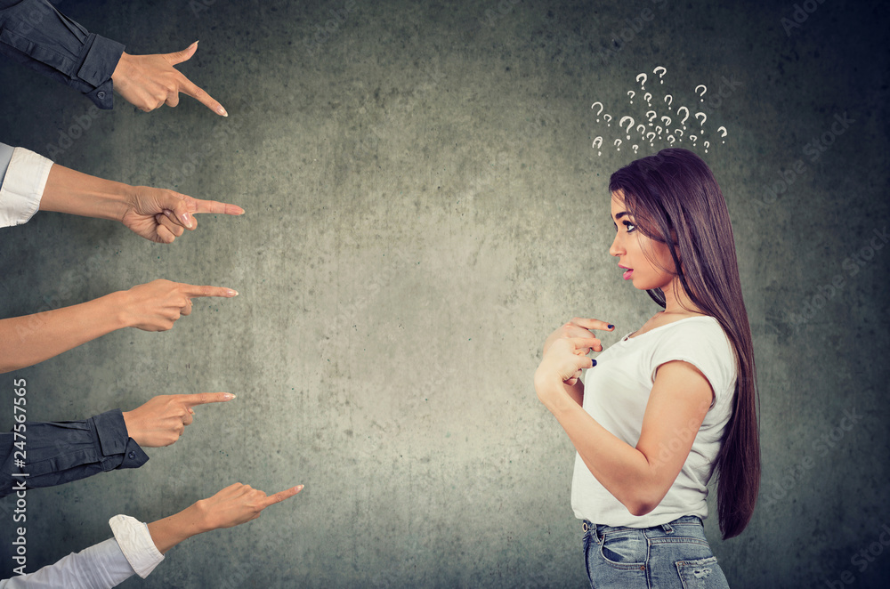 Anxious surprised woman being judged by different people pointing ...