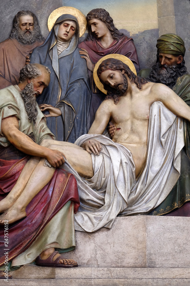 14th Stations of the Cross, Jesus is laid in the tomb and covered in ...