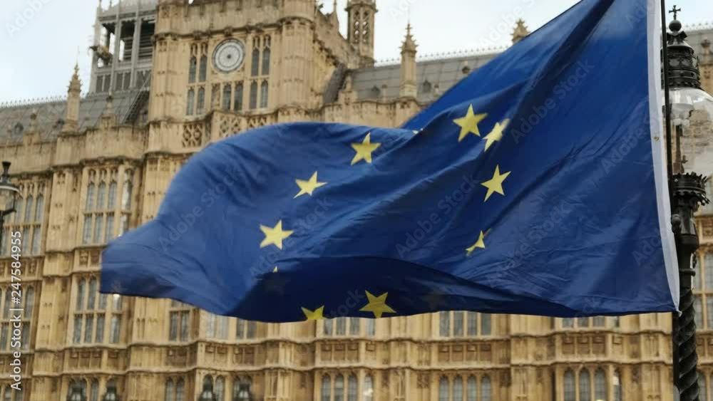 Close-up shot of a large EU flag waving in slow motion against the ...