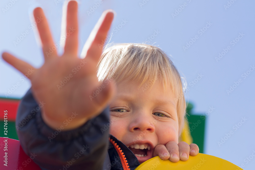 Cute baby boy giving high five to someone. Happy smiling portrait of ...