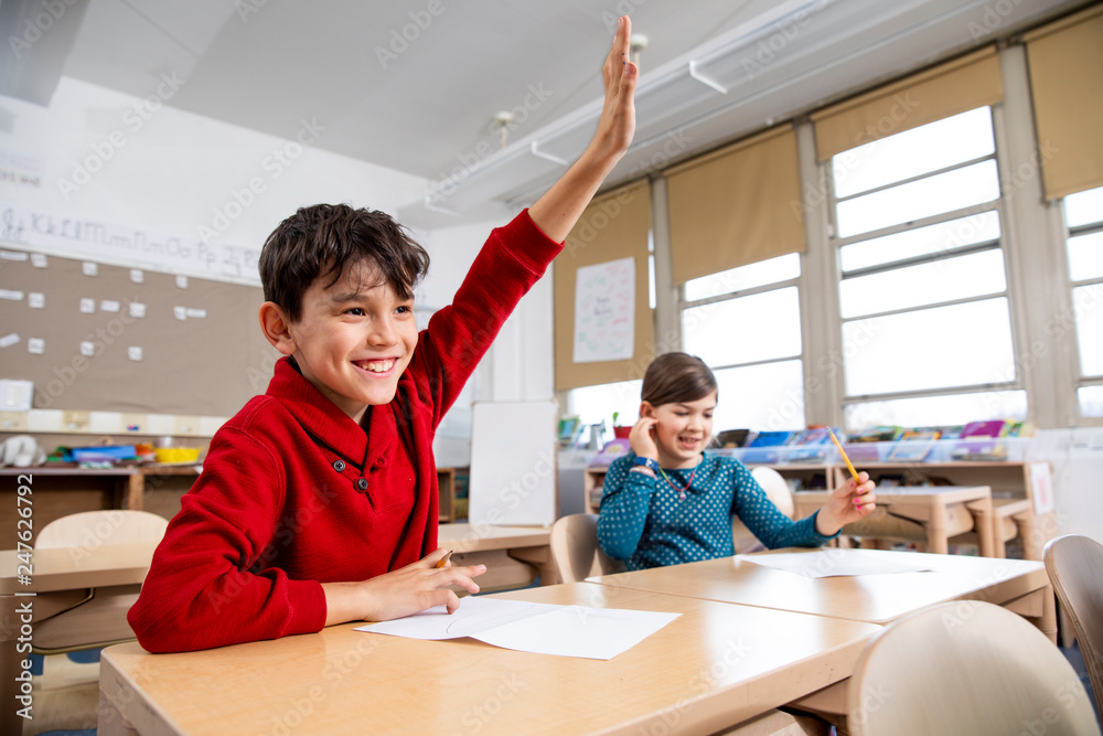 Boy raising hand in class Stock Photo | Adobe Stock