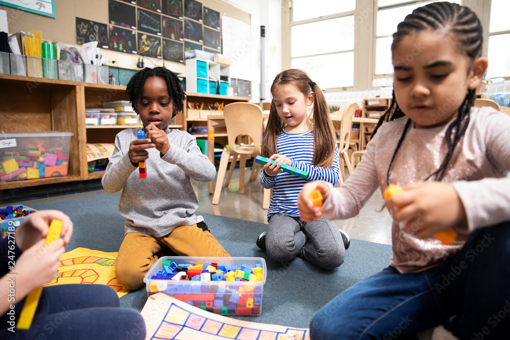 Students playing math game with plastic blocks Stock Photo | Adobe Stock