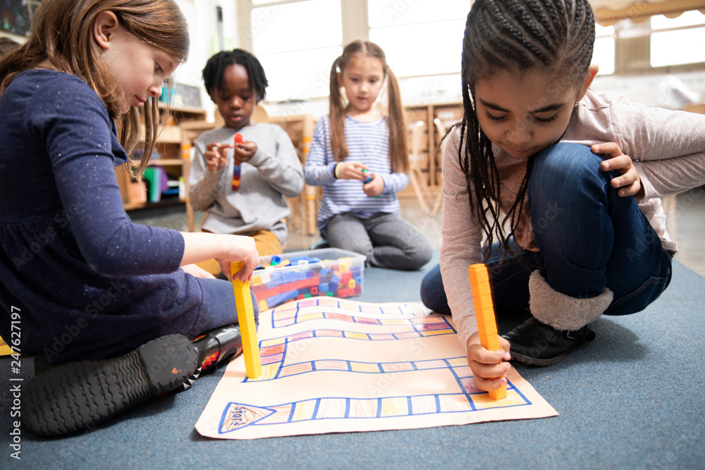 Students playing math game with plastic blocks Stock Photo | Adobe Stock