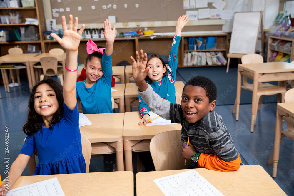 Students raising hands in class Stock Photo | Adobe Stock